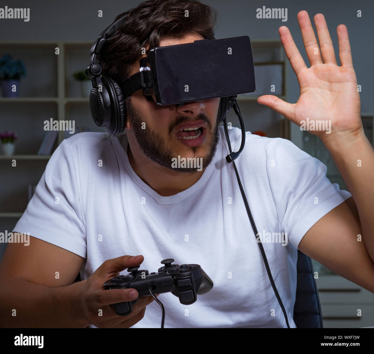 Young man playing games long hours late in the office Stock Photo - Alamy