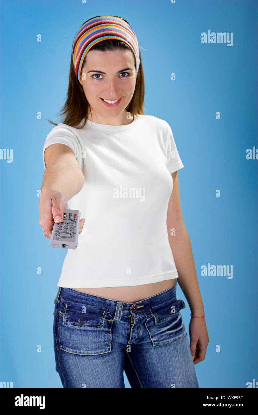 Woman with a remote control over a blue background Stock Photo - Alamy