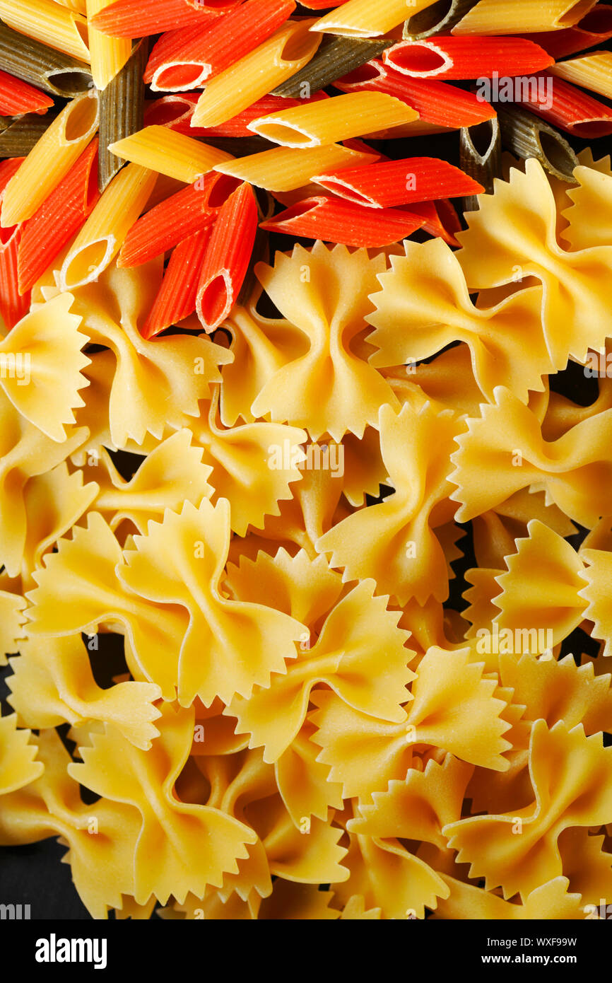 Variety of types and shapes of Italian pasta on black table Stock Photo ...