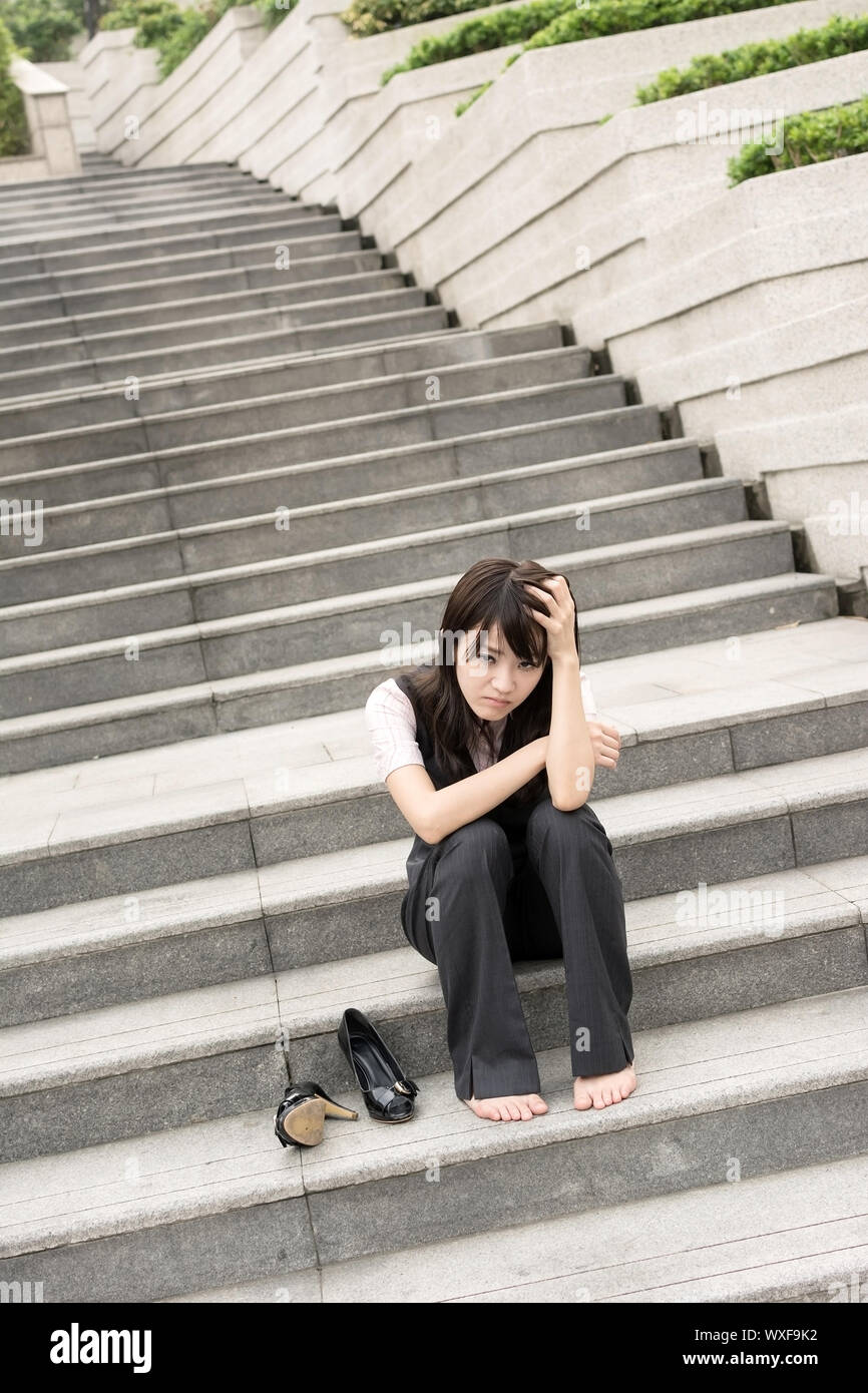 Sad business woman feel worried and stressed in outside of modern city ...