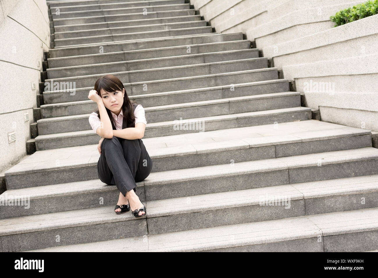 Sad business woman feel worried and stressed in outside of modern city ...