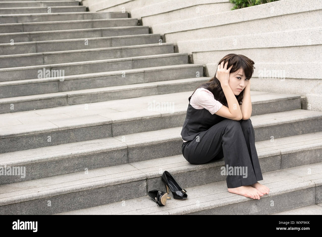 Sad business woman feel worried and stressed in outside of modern city ...