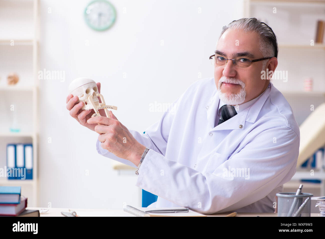 Aged male doctor with skeleton Stock Photo - Alamy