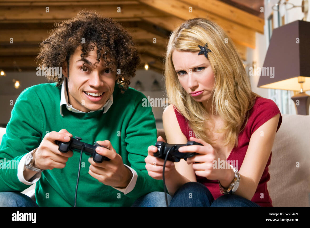 girl feeling awkward at playing videogames Stock Photo - Alamy