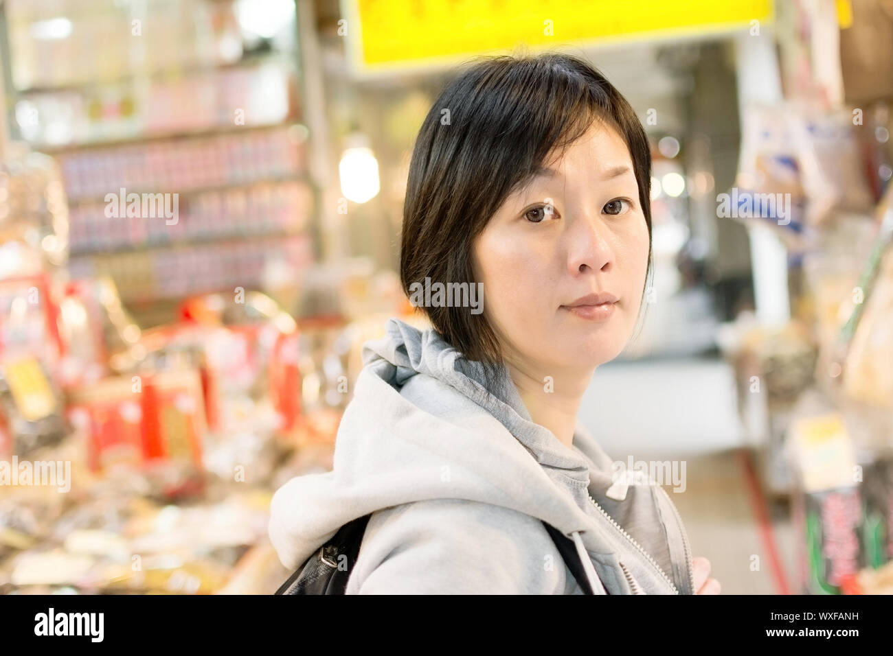 Mature Asian women in sport dress walk at modern street in Taipei ...