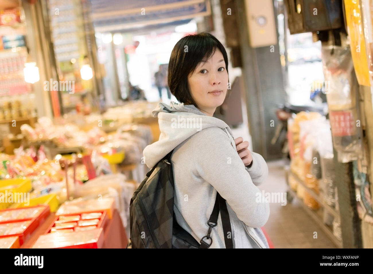 Mature Asian women in sport dress walk at modern street in Taipei ...
