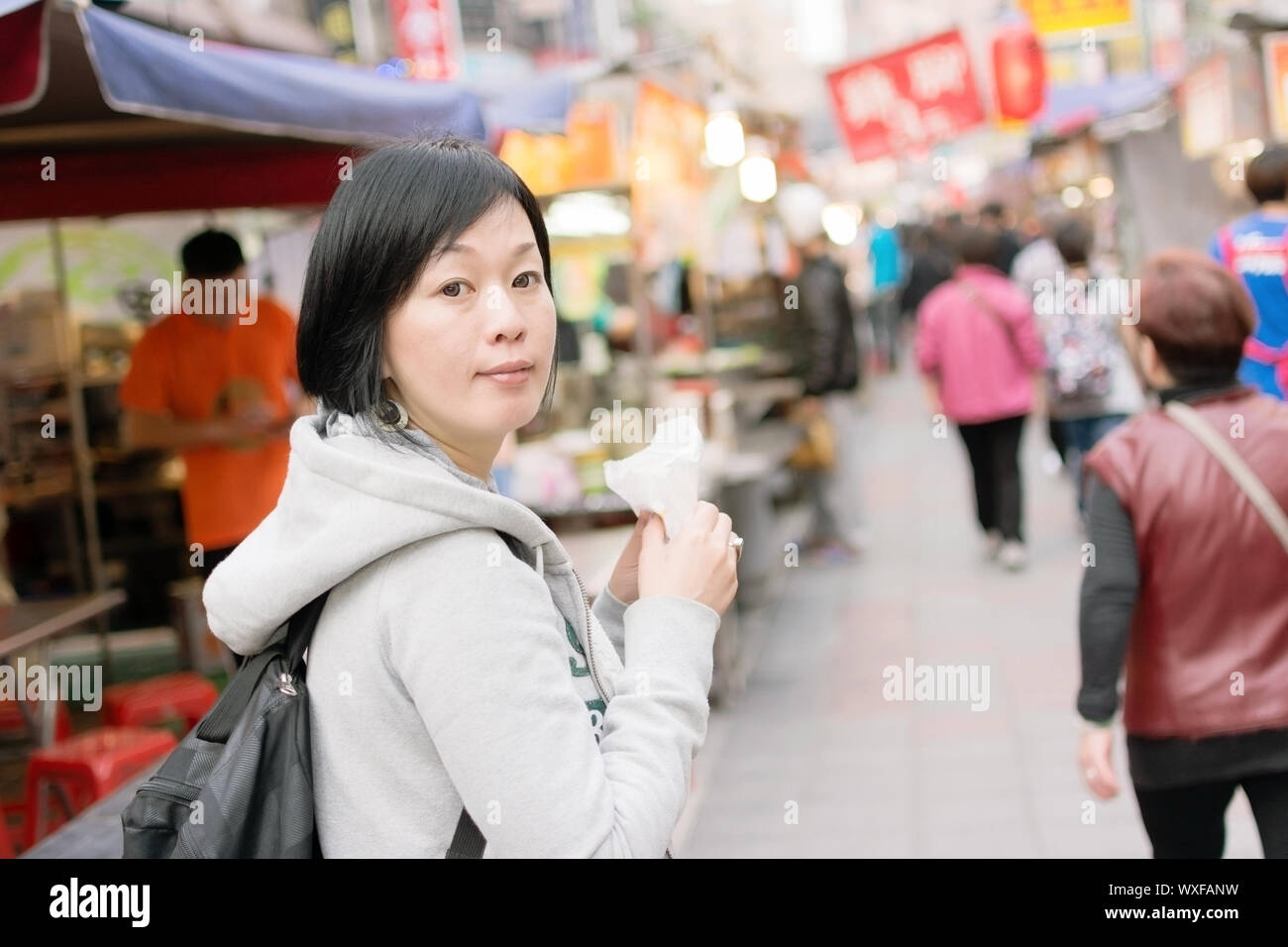 Mature Asian women in sport dress walk at modern street in Taipei ...