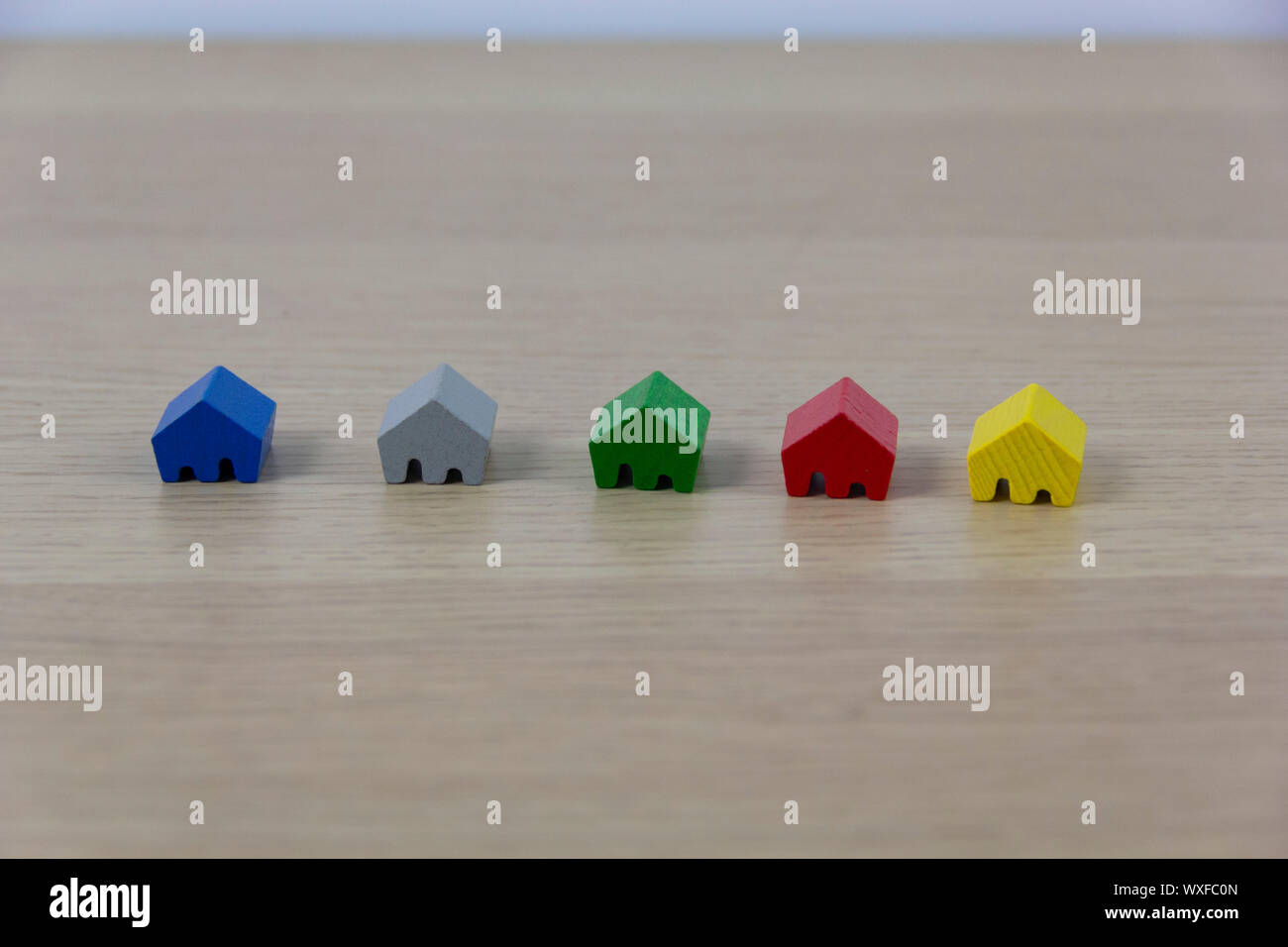 different colored game pieces representing different houses, concept of ...