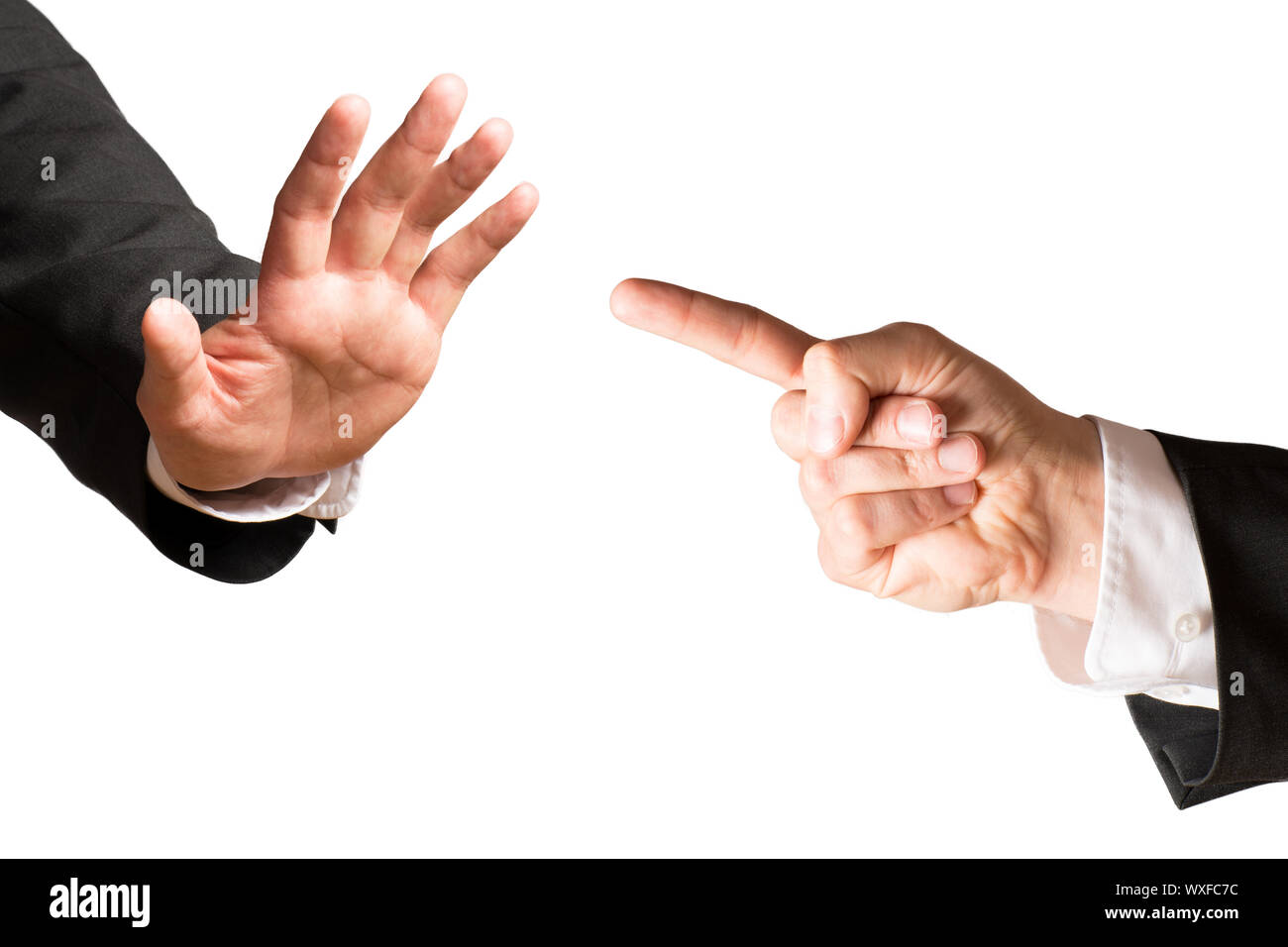 Two hands in suit against white background. The one hand is pointing ...