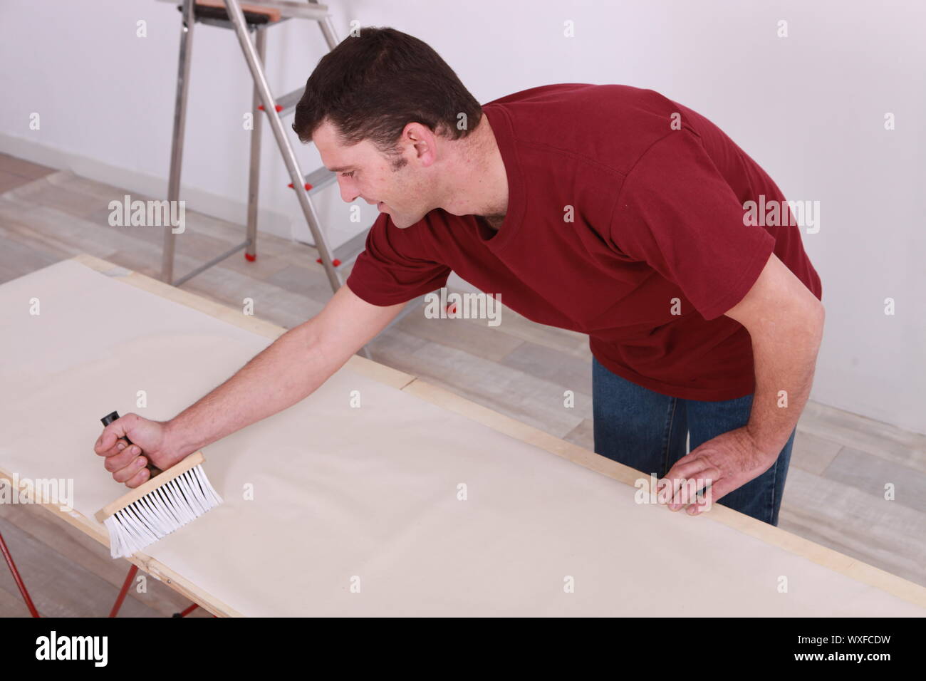 Man gluing paper Stock Photo - Alamy