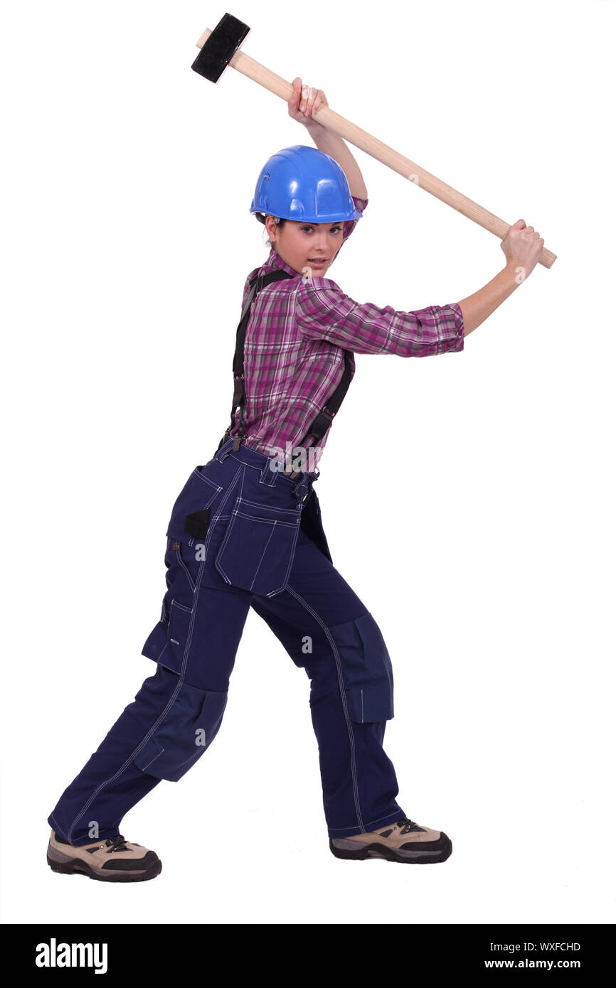 Young woman laborer using hammer isolated on white background Stock ...
