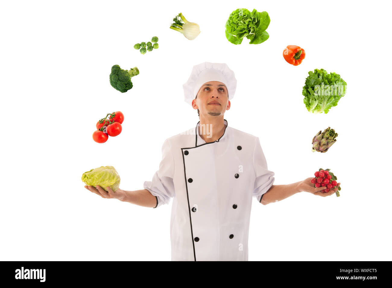 Cook juggling with assortment fresh vegetables isolated over white ... Cook juggling with assortment fresh vegetables isolated over white ...