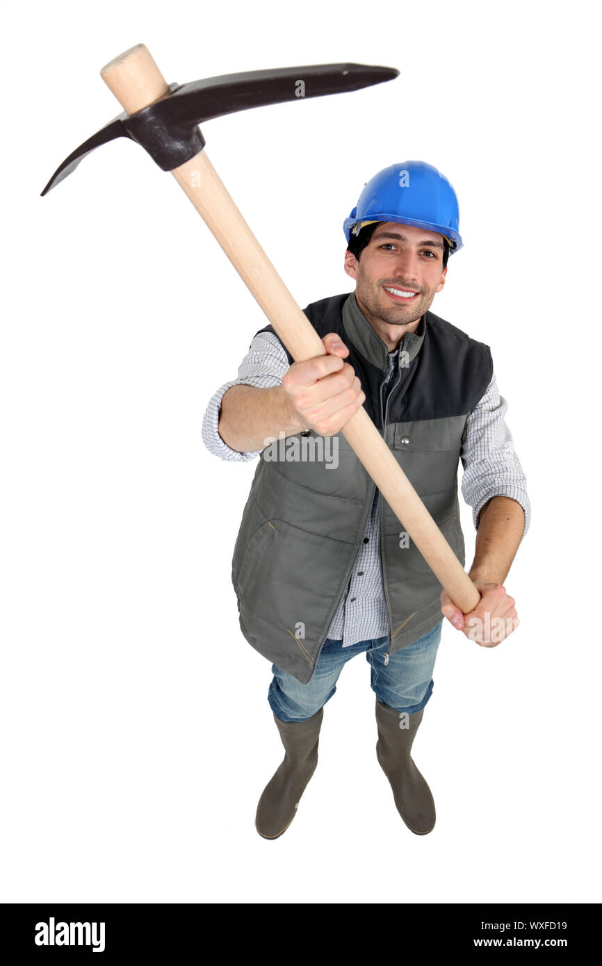 Man wielding pick-axe Stock Photo - Alamy