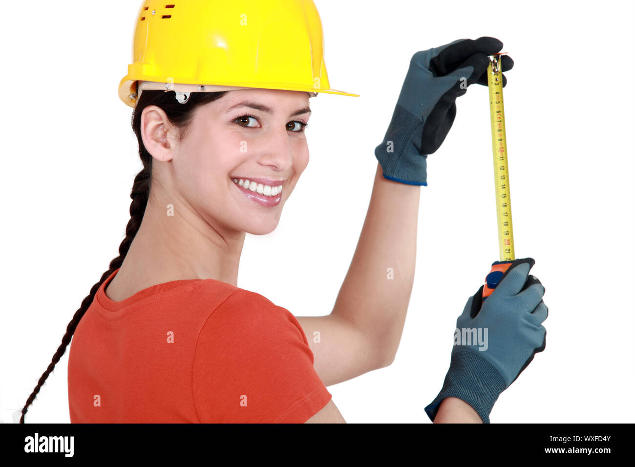 Young female laborer using measuring tape Stock Photo - Alamy