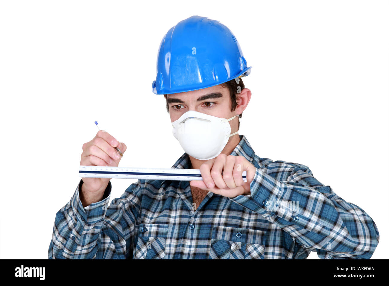 A manual worker with a ruler Stock Photo - Alamy