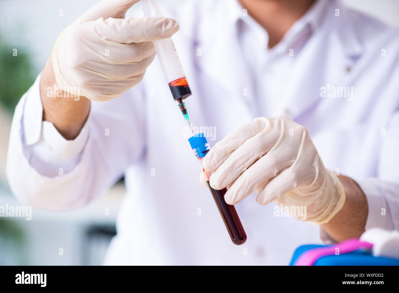 Young lab assistant testing blood samples in hospital Stock Photo - Alamy