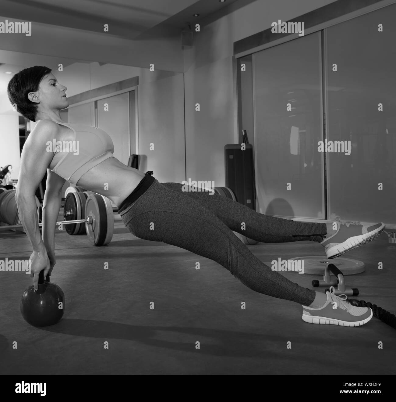 Crossfit fitness woman push ups with Kettlebell rear pushup exercise ...