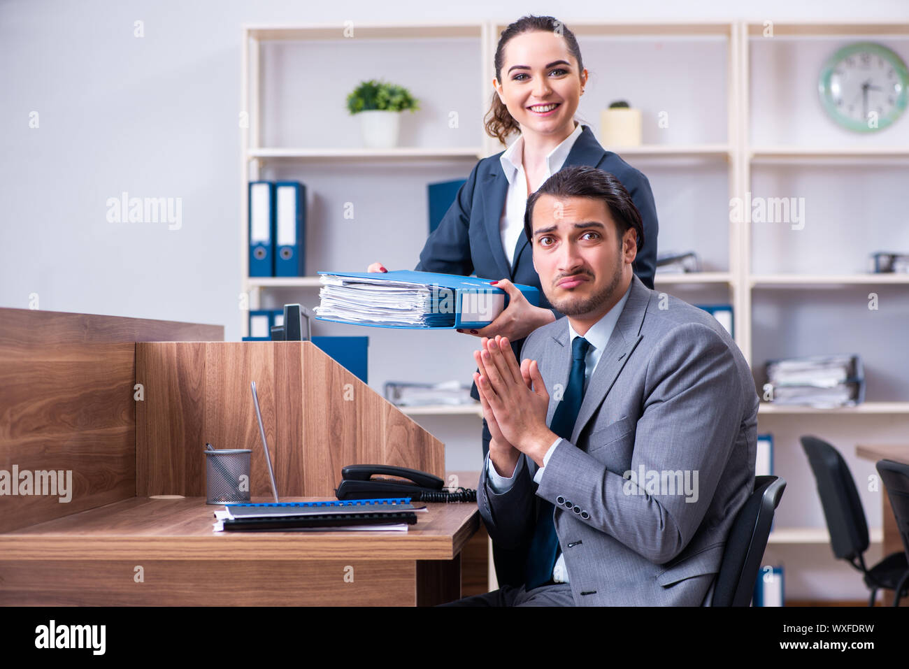 Two employees working in the office Stock Photo - Alamy
