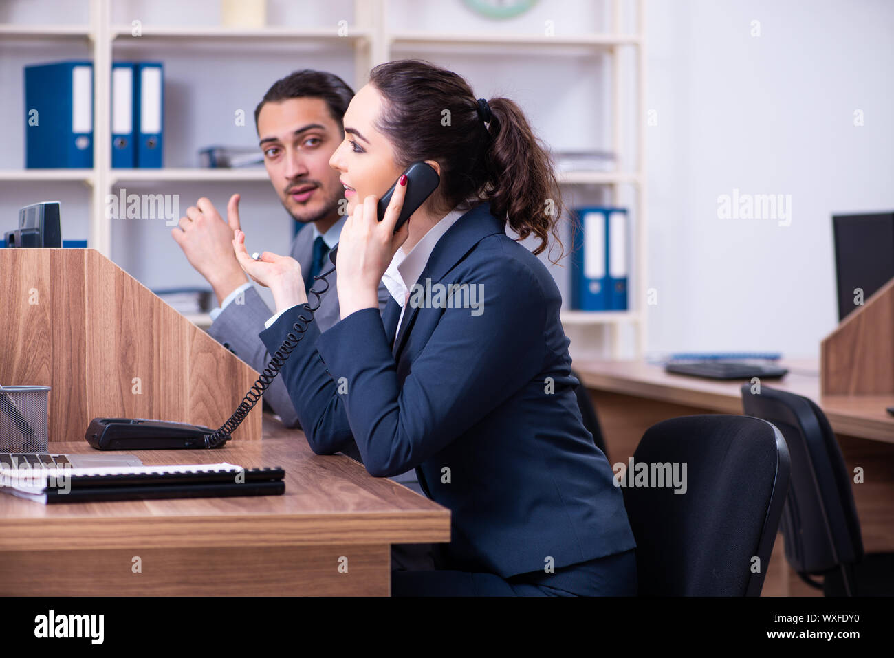 Two employees working in the office Stock Photo - Alamy
