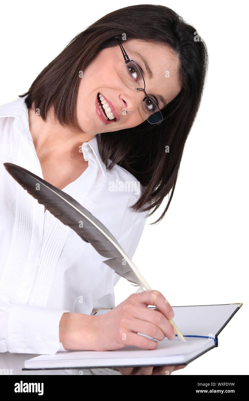 Woman writing with pen Stock Photo - Alamy