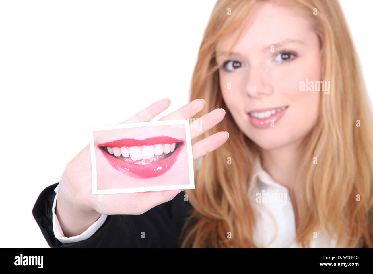 Woman with picture of large smile in hand Stock Photo - Alamy