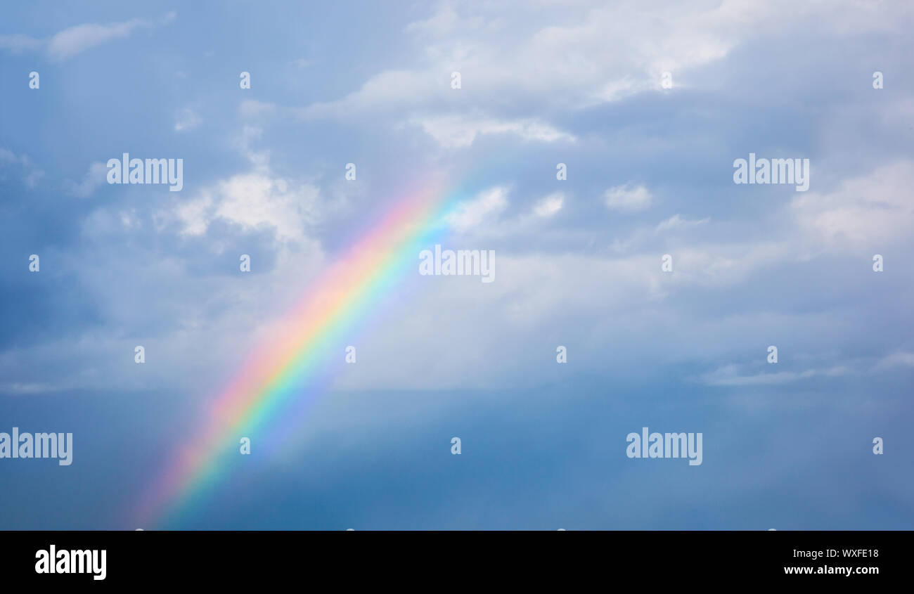 Beautiful colorful rainbow in cloudy sky, abstract background, natural ...