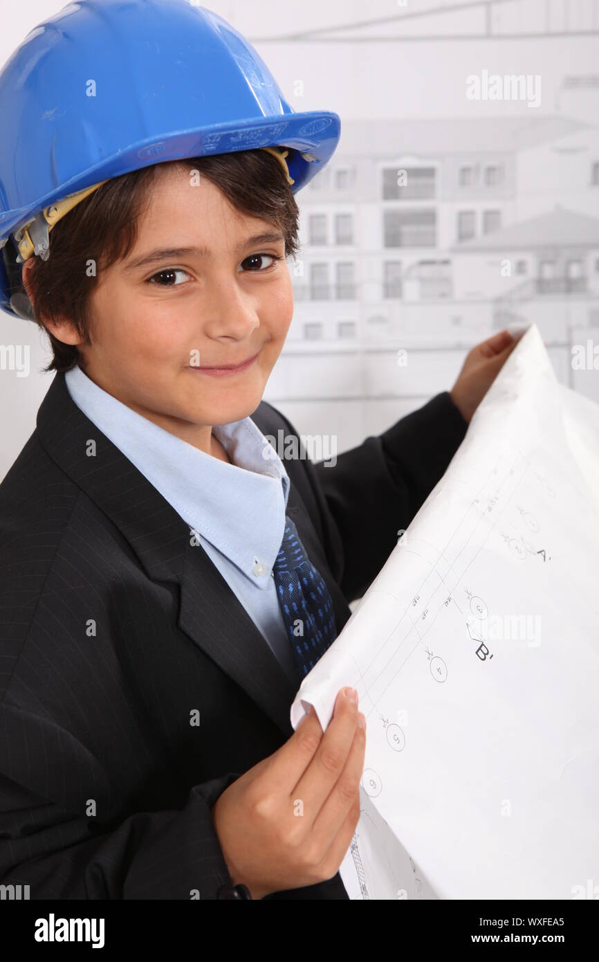 Boy with helmet and blueprints Stock Photo - Alamy