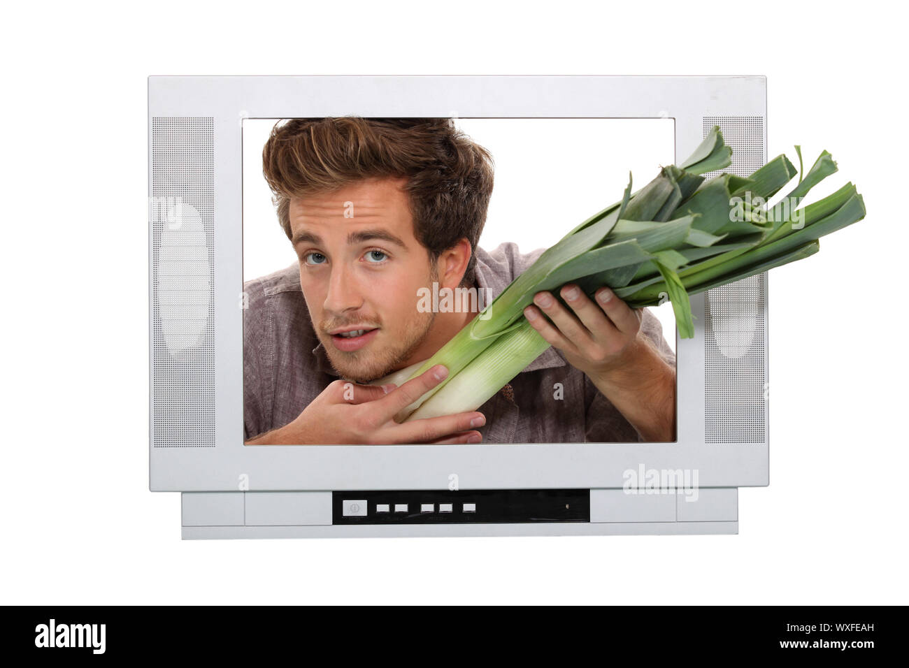 Man holding leek coming out of television Stock Photo - Alamy