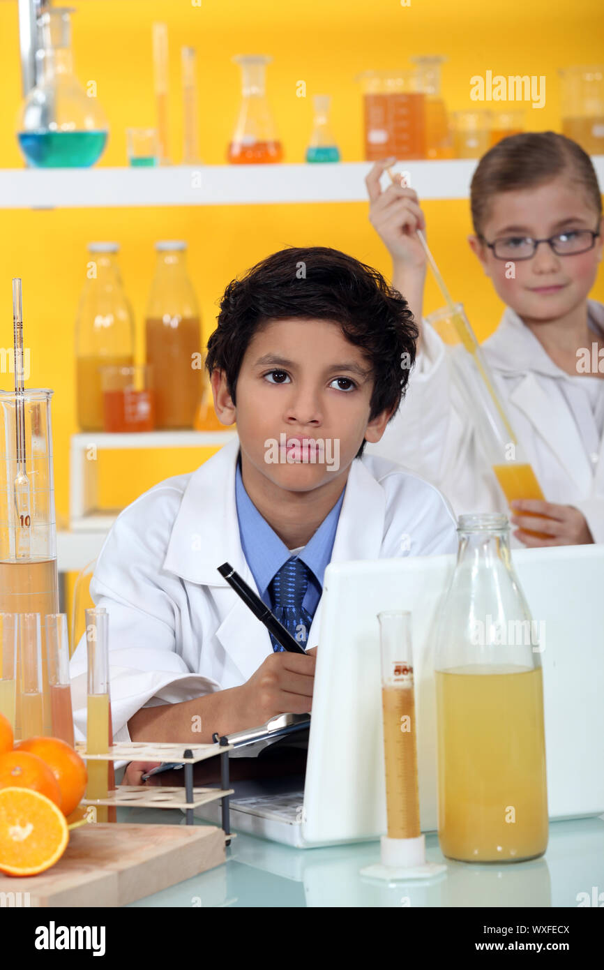 Kids performing science experiment Stock Photo - Alamy