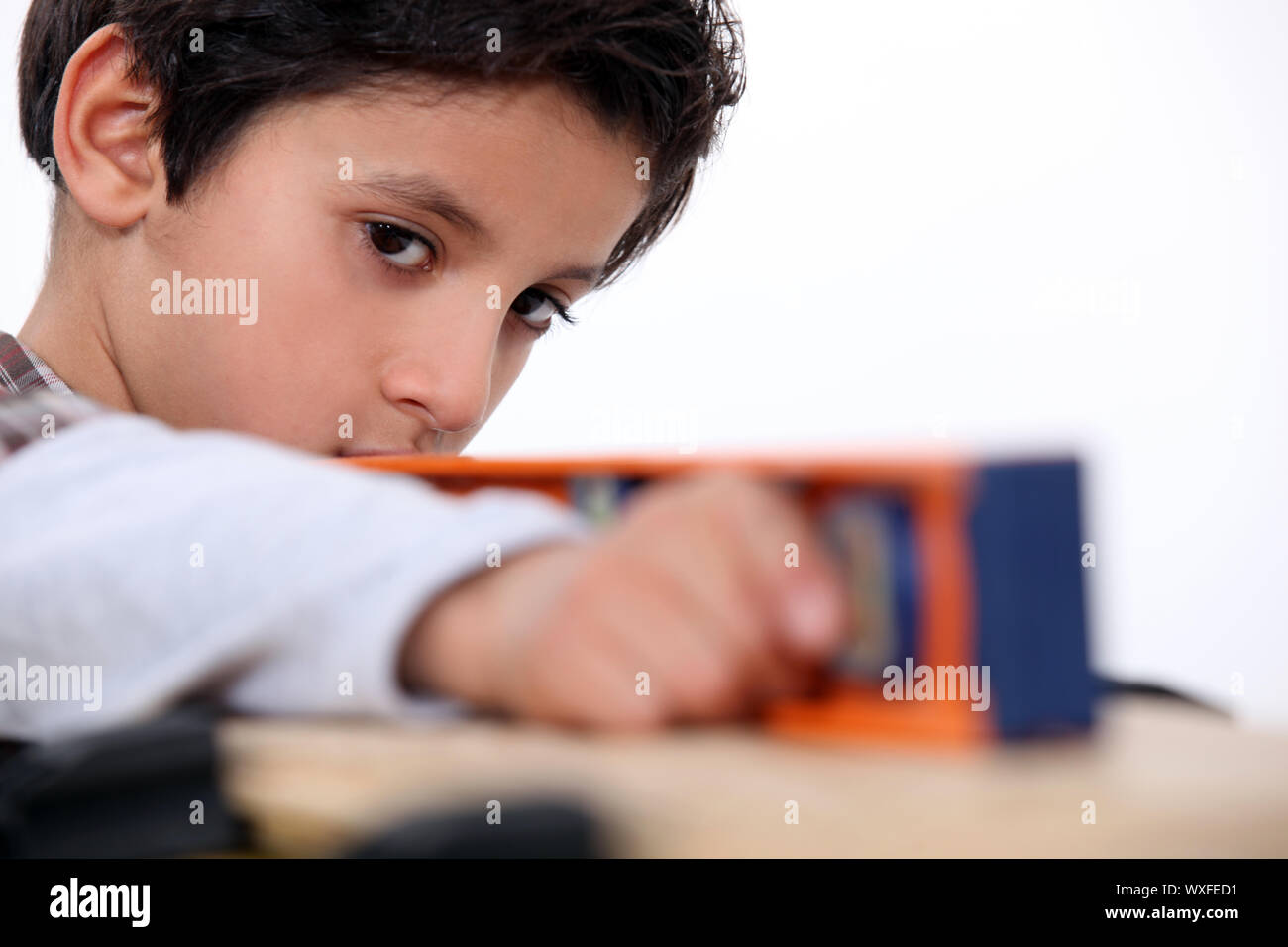 Little boy using spirit-level Stock Photo - Alamy