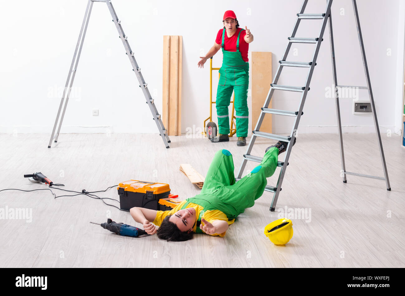 Injured worker and his workmate Stock Photo - Alamy