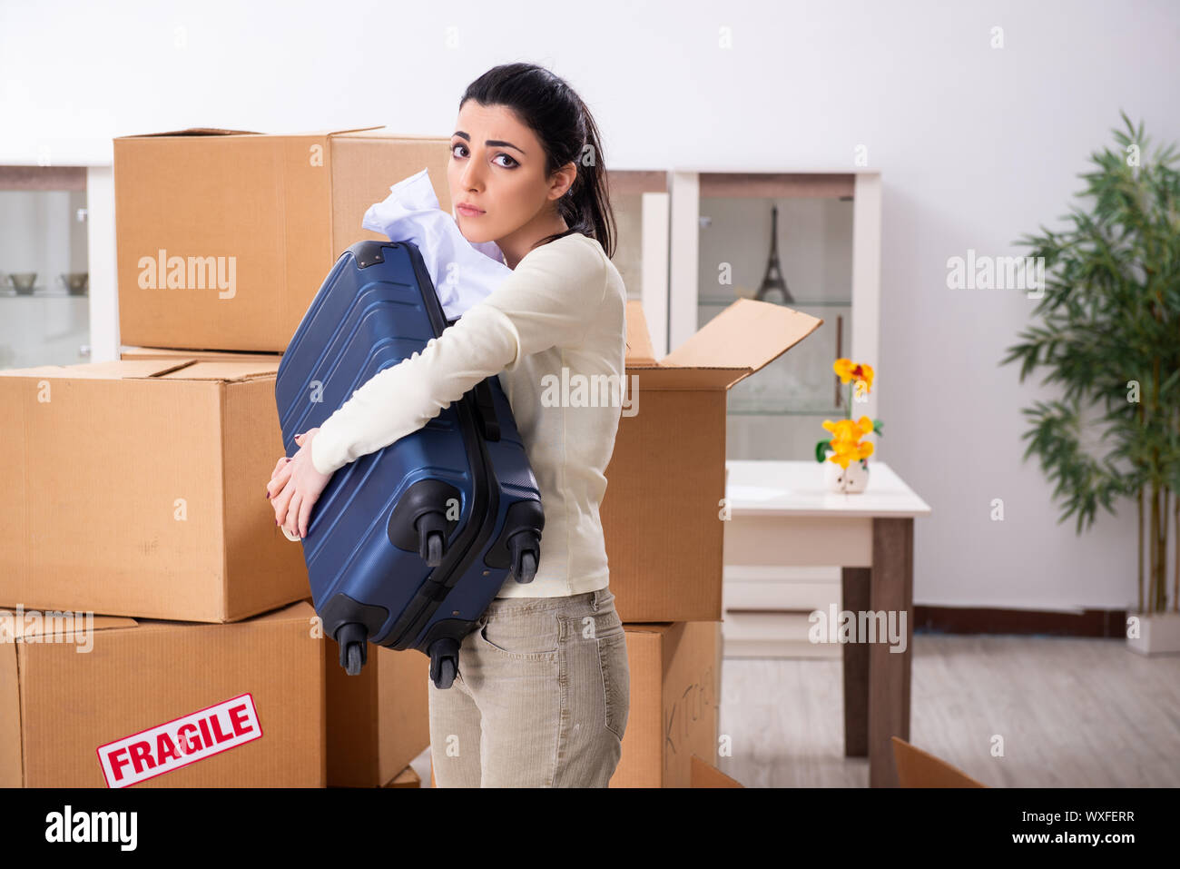 Young woman moving to new flat Stock Photo - Alamy