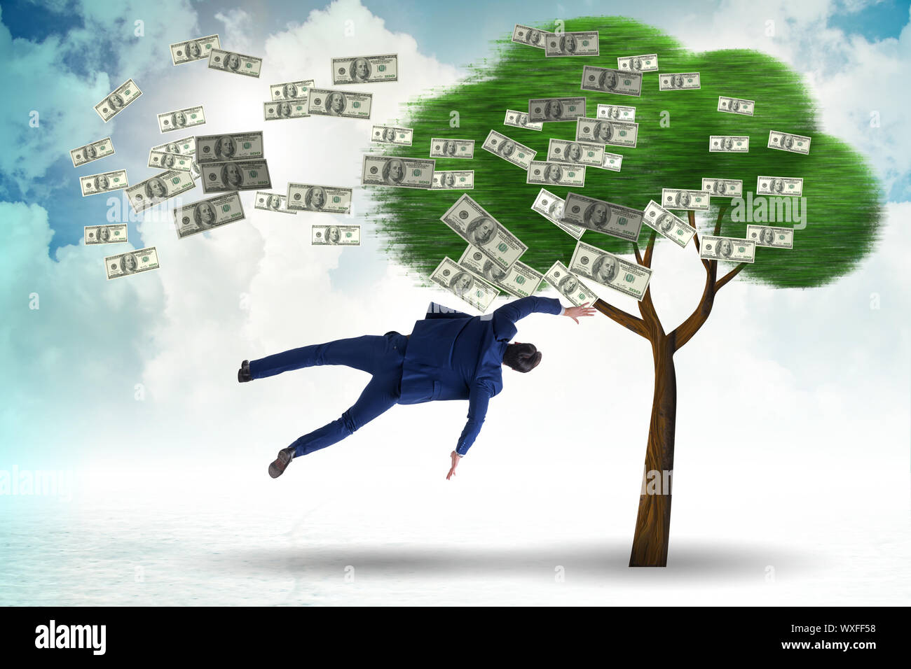 Businessman blown away from the money tree Stock Photo - Alamy