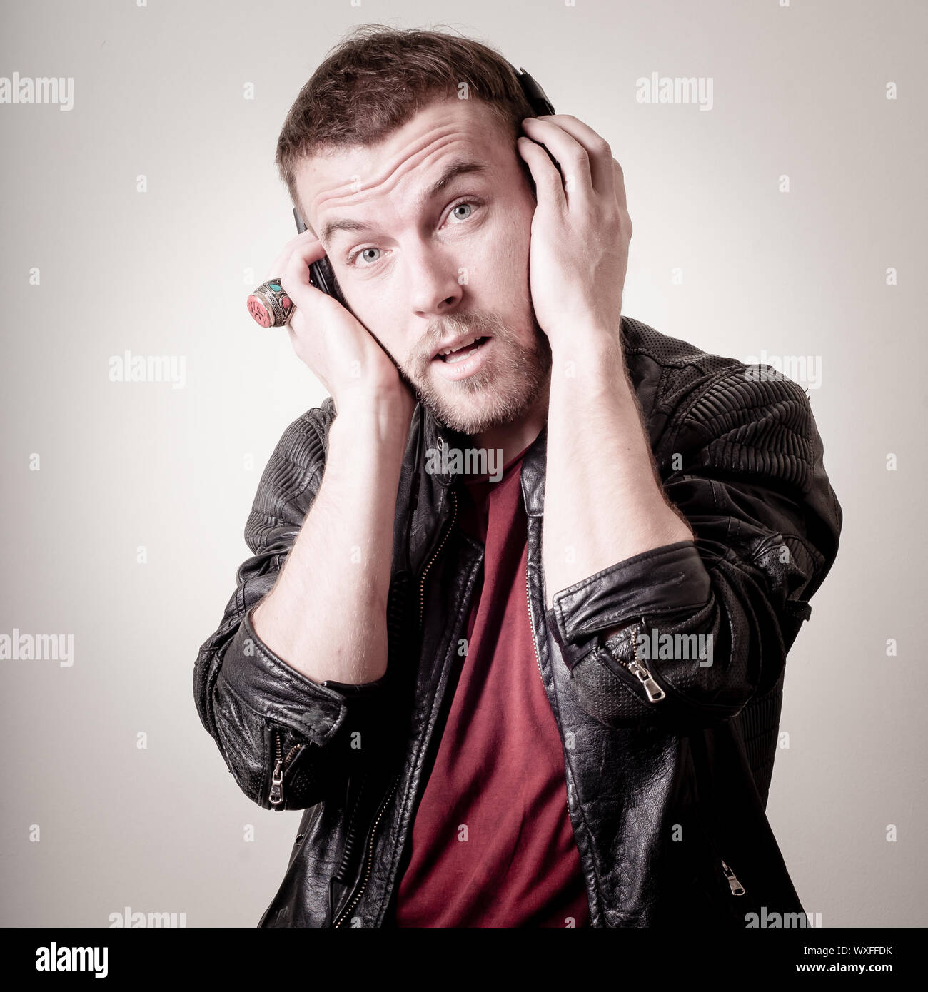 stylish hipster listening to music on gray background Stock Photo - Alamy
