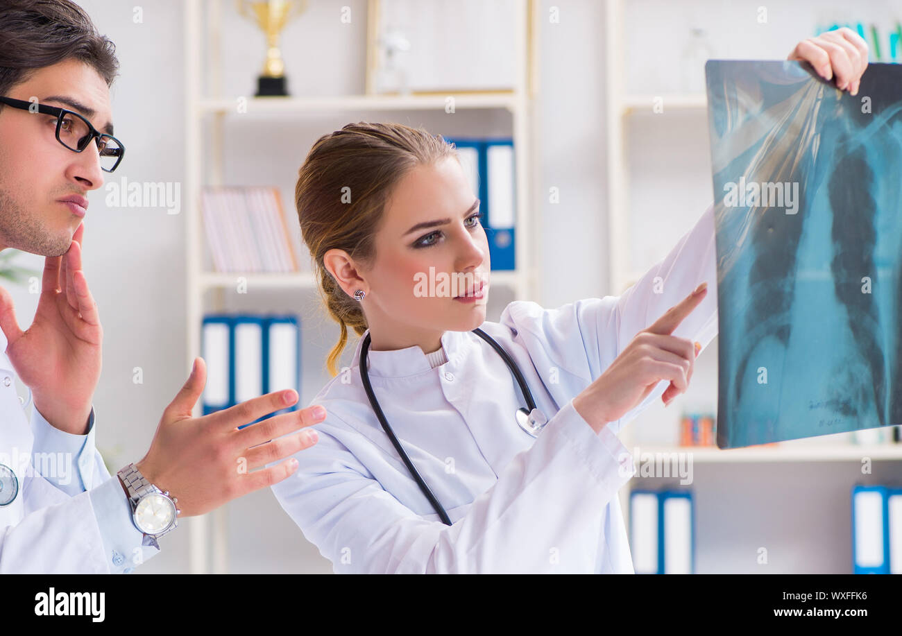 Two doctors examining x-ray images of patient for diagnosis Stock Photo ...