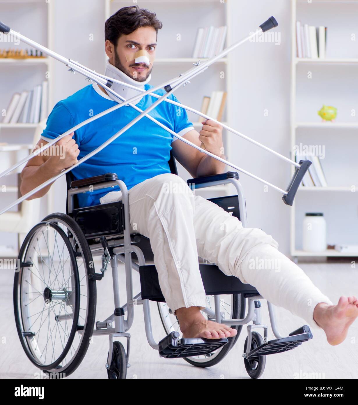 Injured young man recovering at home Stock Photo - Alamy