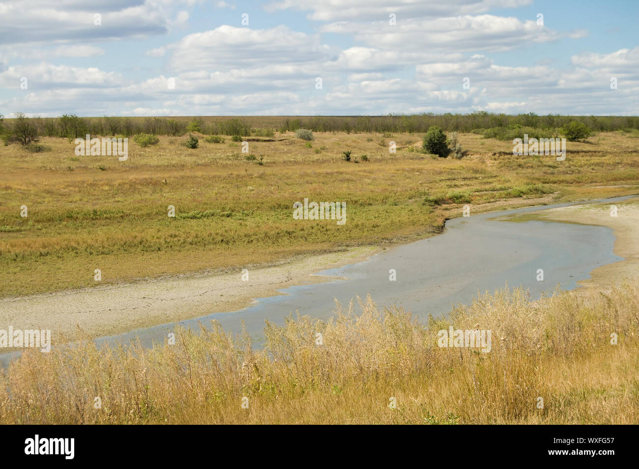 view of steppe lowland calm river under blue sky Stock Photo - Alamy