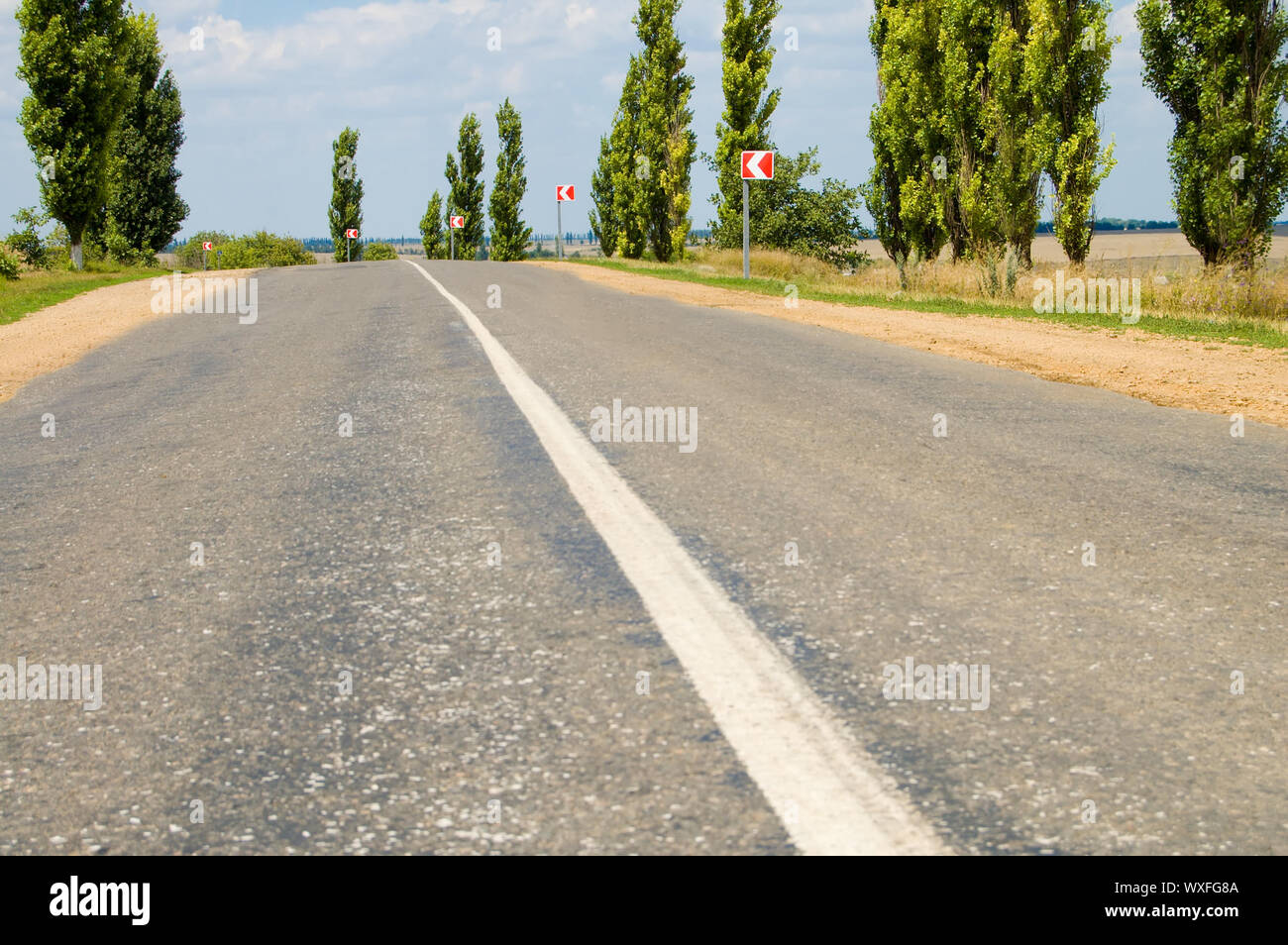 a line on rural road with the image of sign-boards Stock Photo - Alamy