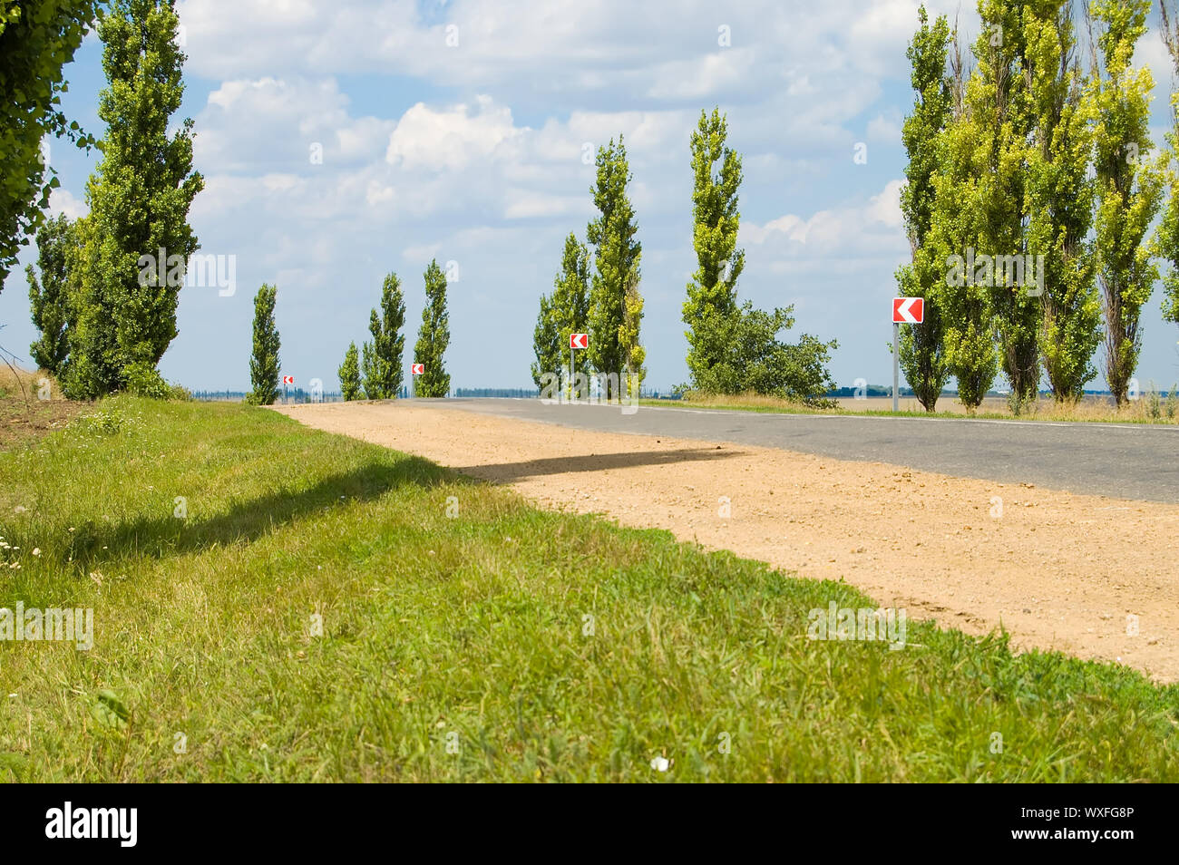 a turn of rural road is to the left with the image of sign-boards Stock ...