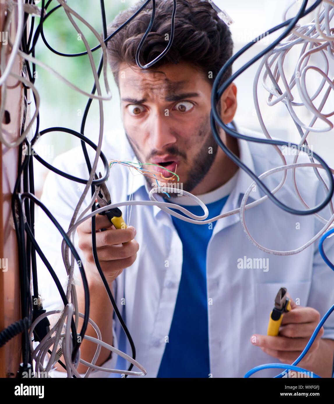 Computer repairman working on repairing network in IT workshop Stock ...
