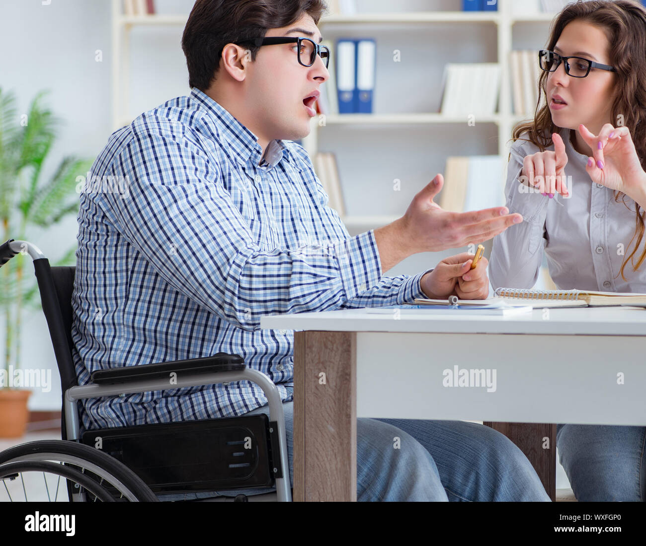 Disabled student studying and preparing for college exams Stock Photo ...