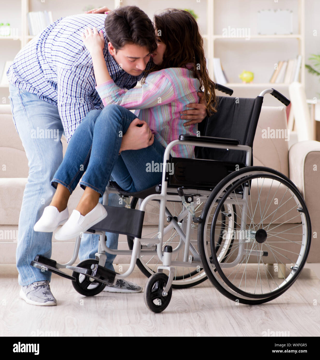 Young family taking care of each other Stock Photo - Alamy