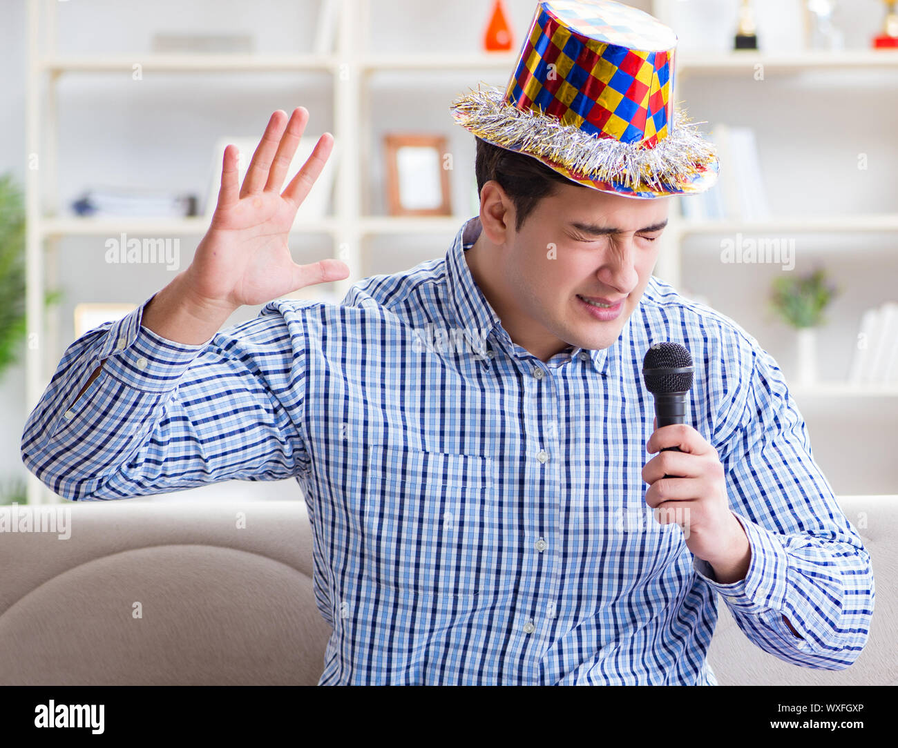 Funny man singing songs in karaoke at home Stock Photo - Alamy