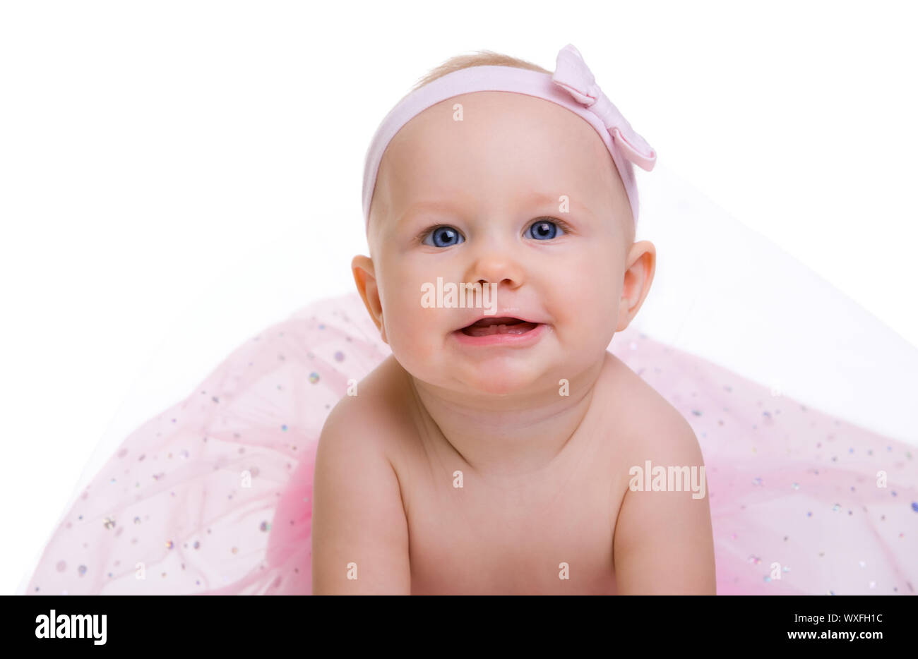 Portrait of adorable baby girl showing her first teeth. Isolated on ...