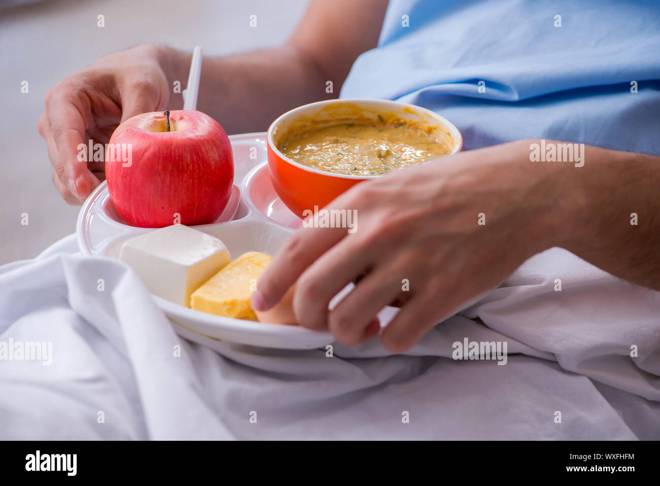 Male patient eating food in the hospital Stock Photo - Alamy