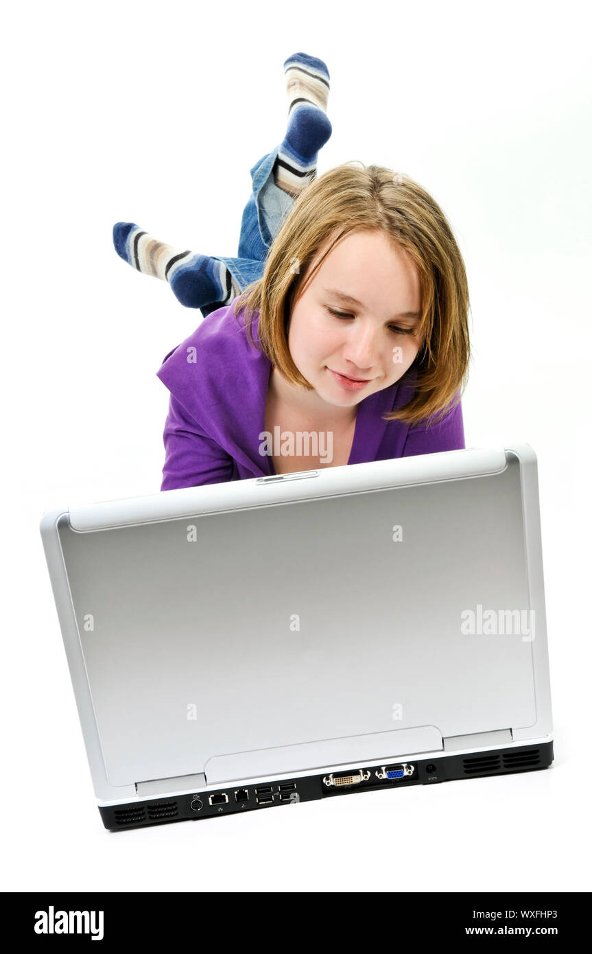 Young girl lying down with laptop computer Stock Photo - Alamy