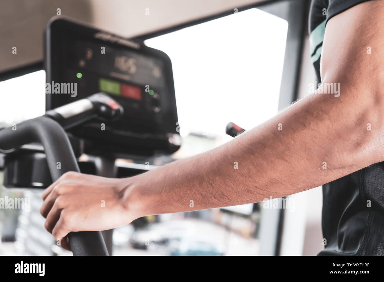 Overweight man training exercise bike hi-res stock photography and ...