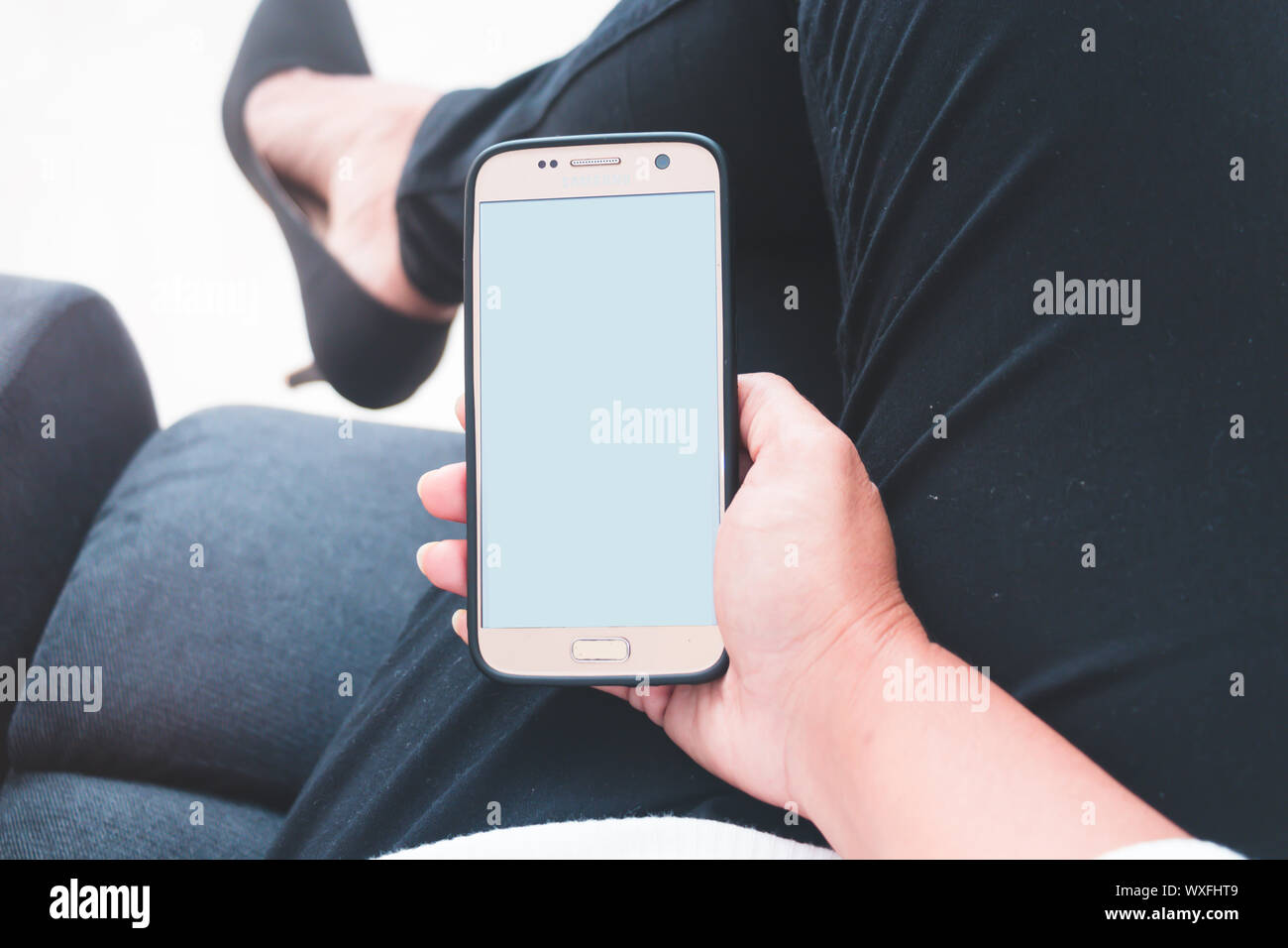Back view close up of a woman hand using a smart phone Stock Photo - Alamy