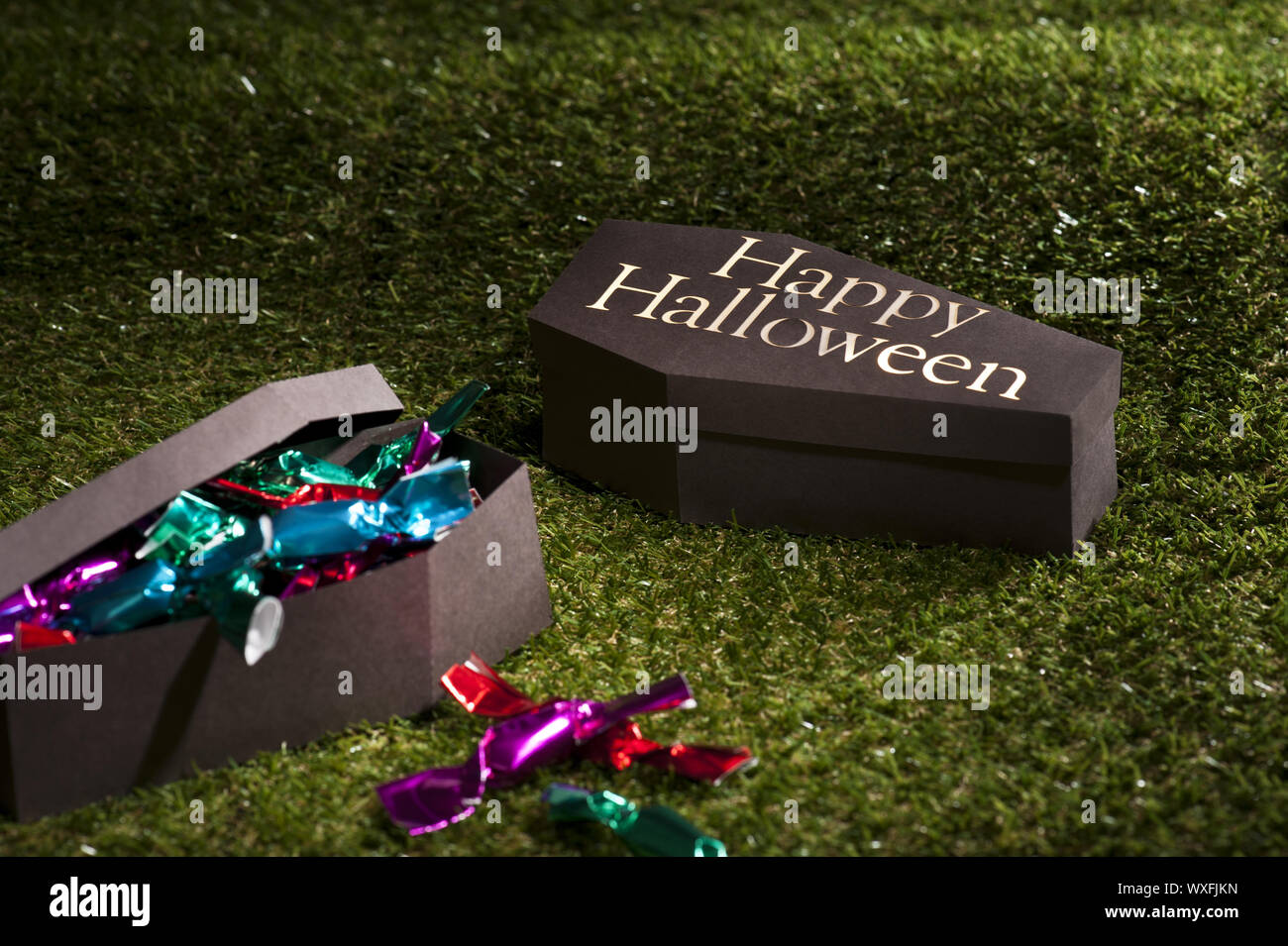 Halloween coffin on lawn with sweets and candies Stock Photo - Alamy