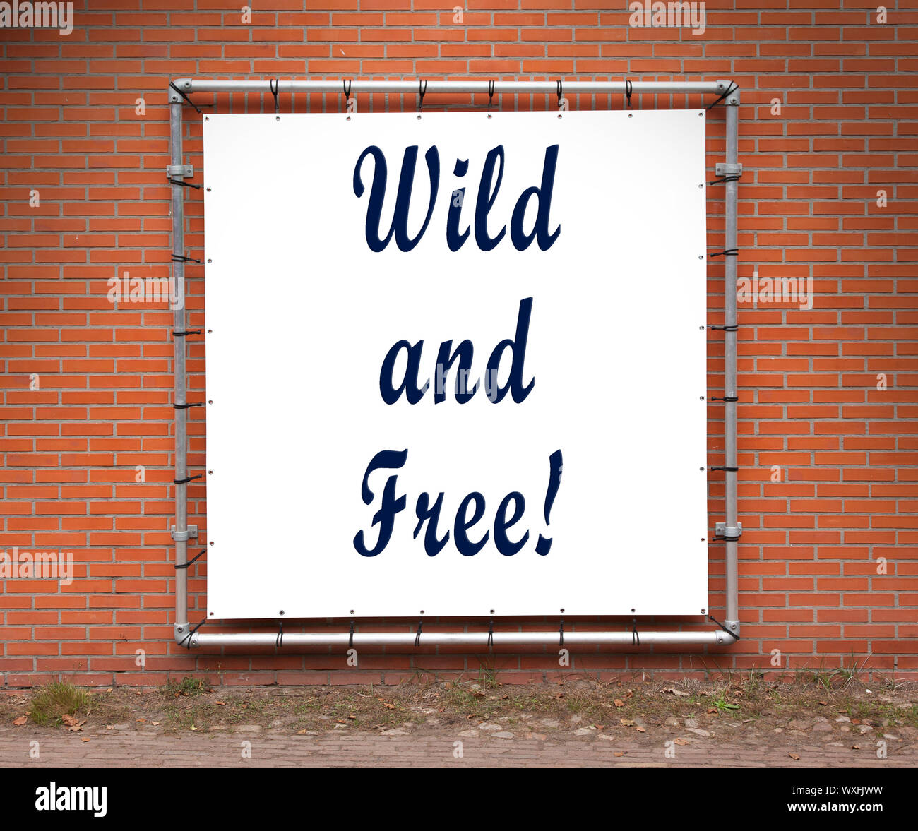 Large message written on white plastic, on a wall - Wild and free Stock ...